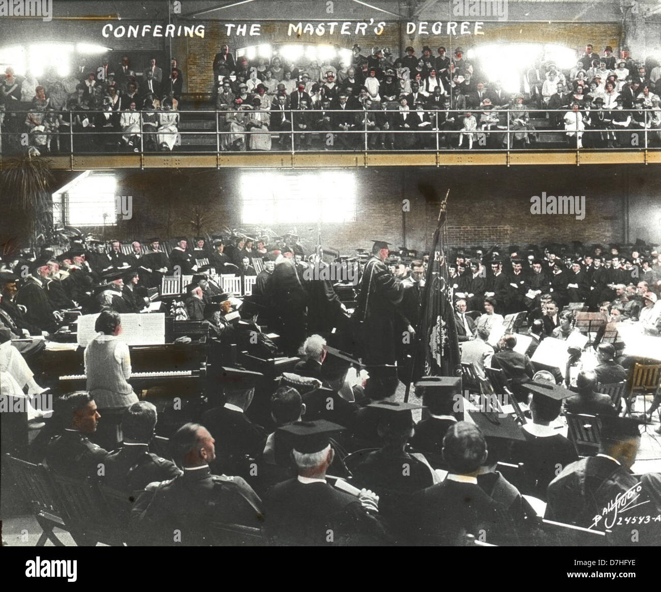 This image shows a historical moment of conferring a Master's Degree ...