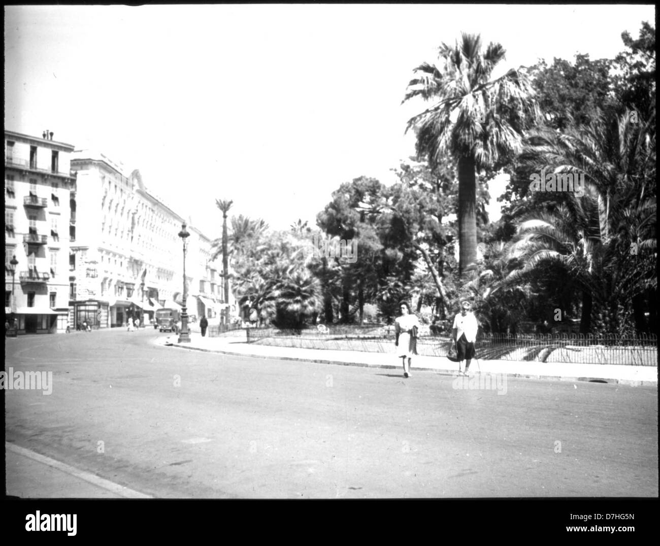 This post-WWII photograph captures a French street scene, depicting the ...