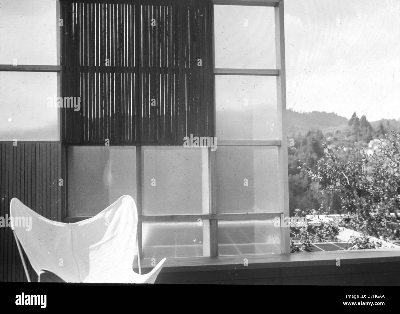 Patio screen and chair overlooking enclosed garden Stock Photo - Alamy