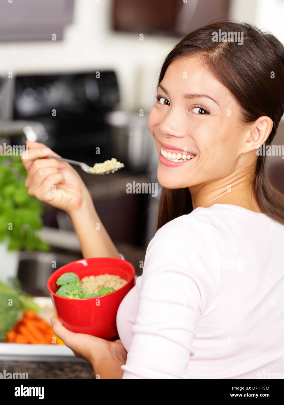 Woman eating quinoa / broccoli salad. Eat healthy food lifestyle ...