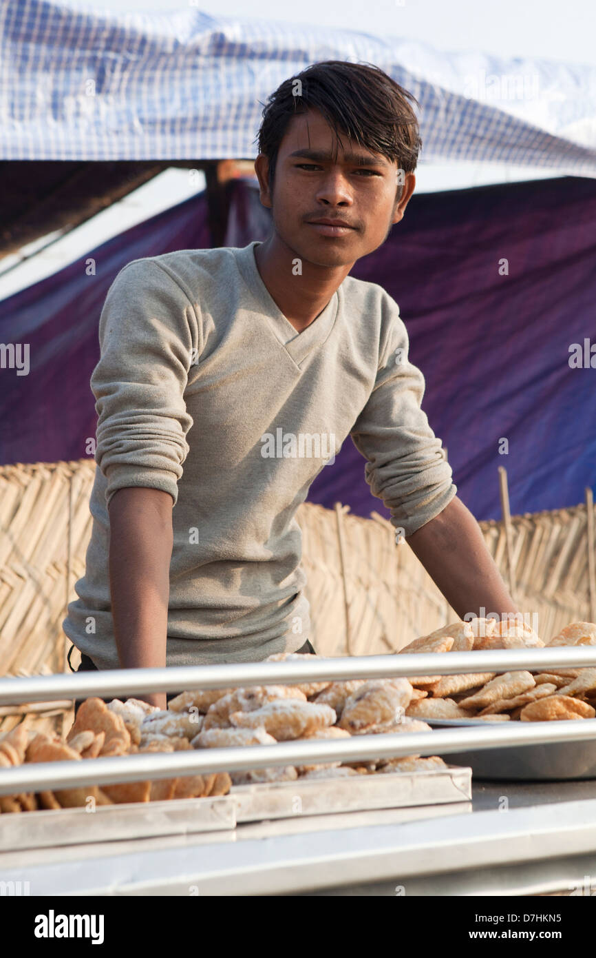 A boy manning a food stall in India Stock Photo - Alamy