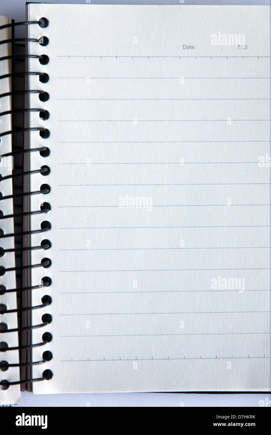 Notebook resting on a white background and the text written on the copy ...