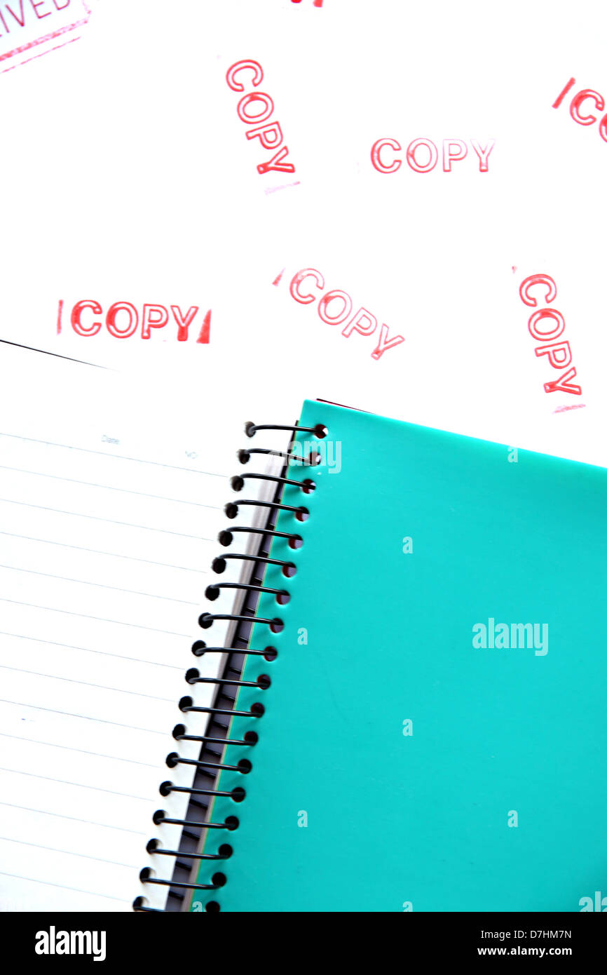 Notebook resting on a white background and the text written on the copy ...
