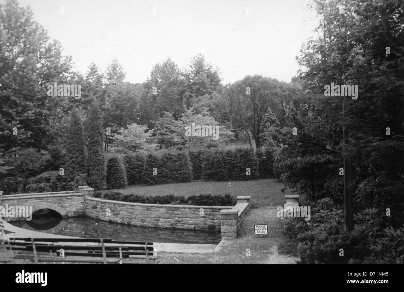 This image features a park with a sign reading 'Please Keep Off Stage ...