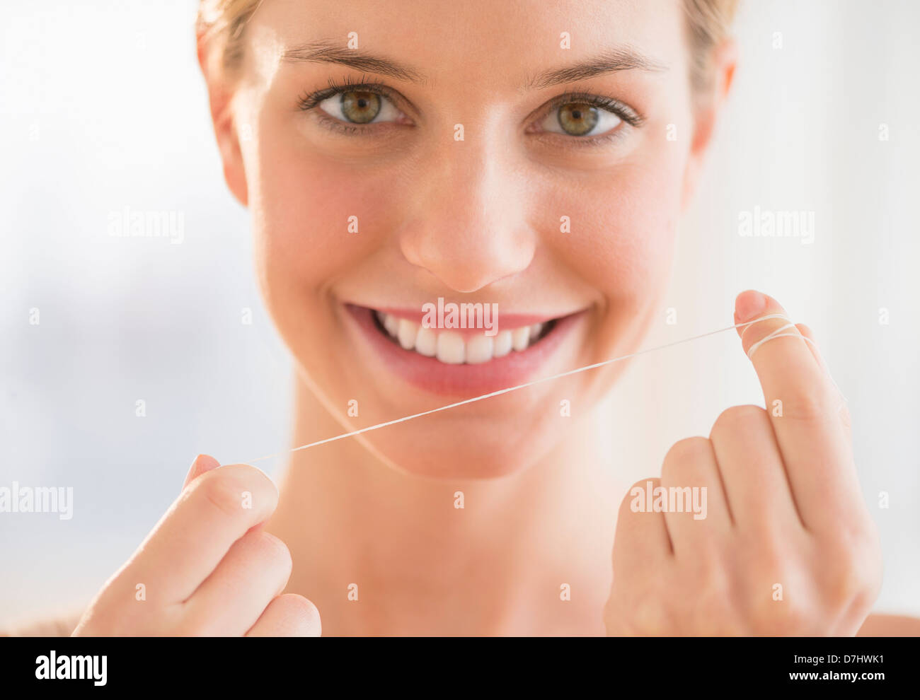 Portrait of woman flossing teeth Stock Photo - Alamy
