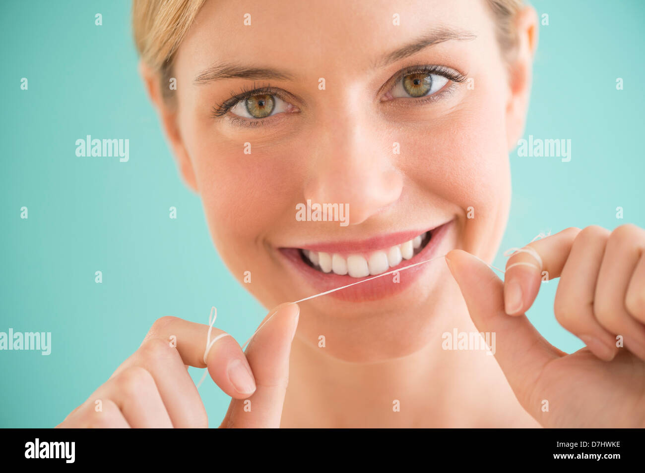 Portrait of woman flossing teeth Stock Photo - Alamy