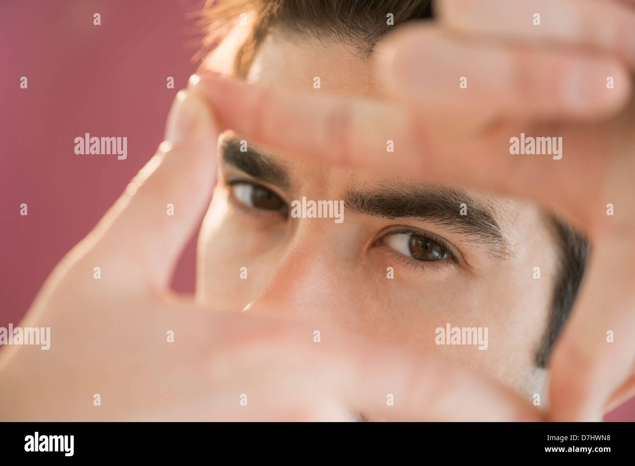 Portrait of man making finger frame Stock Photo - Alamy