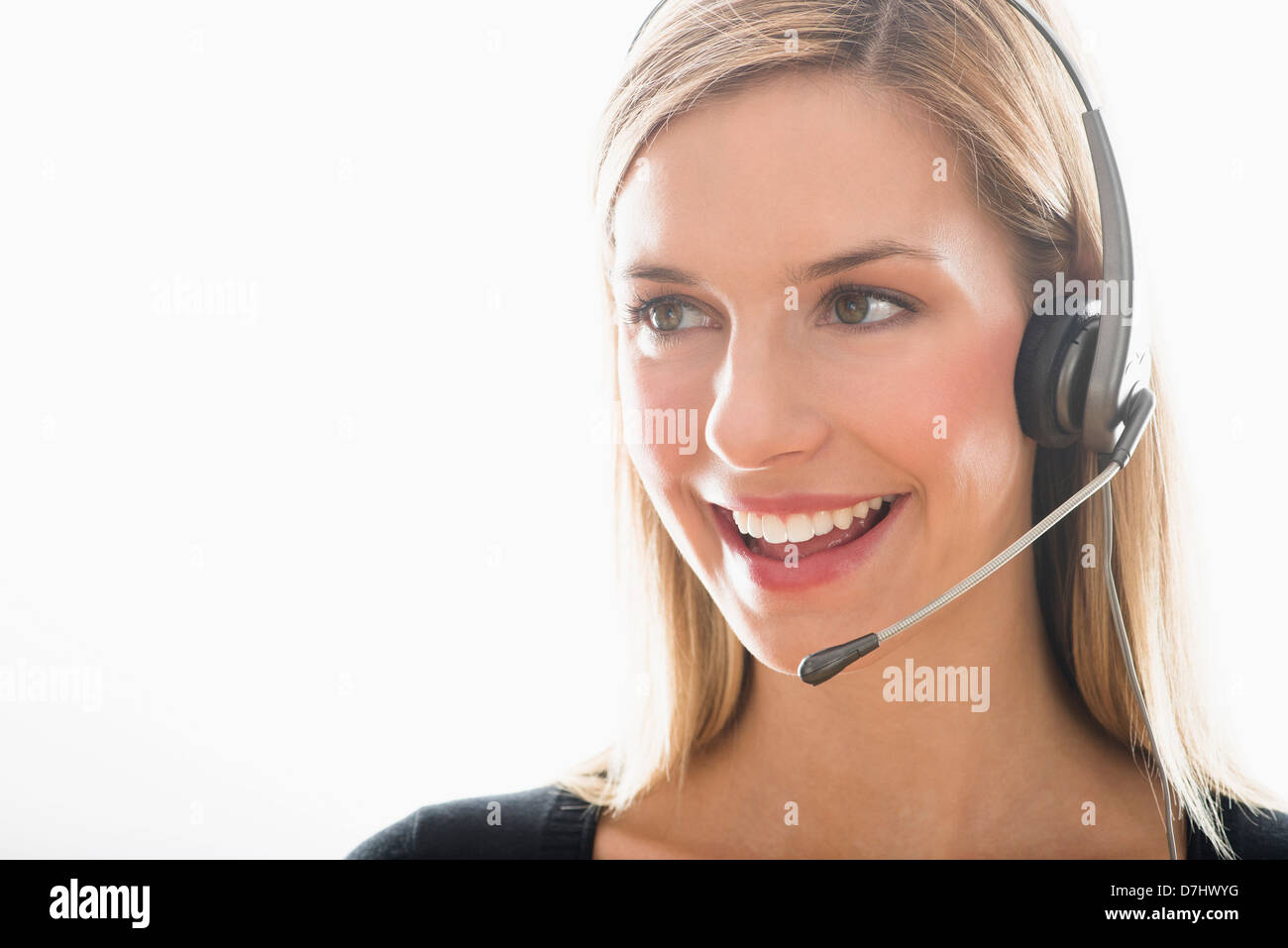 Studio portrait of young woman wearing headset Stock Photo - Alamy