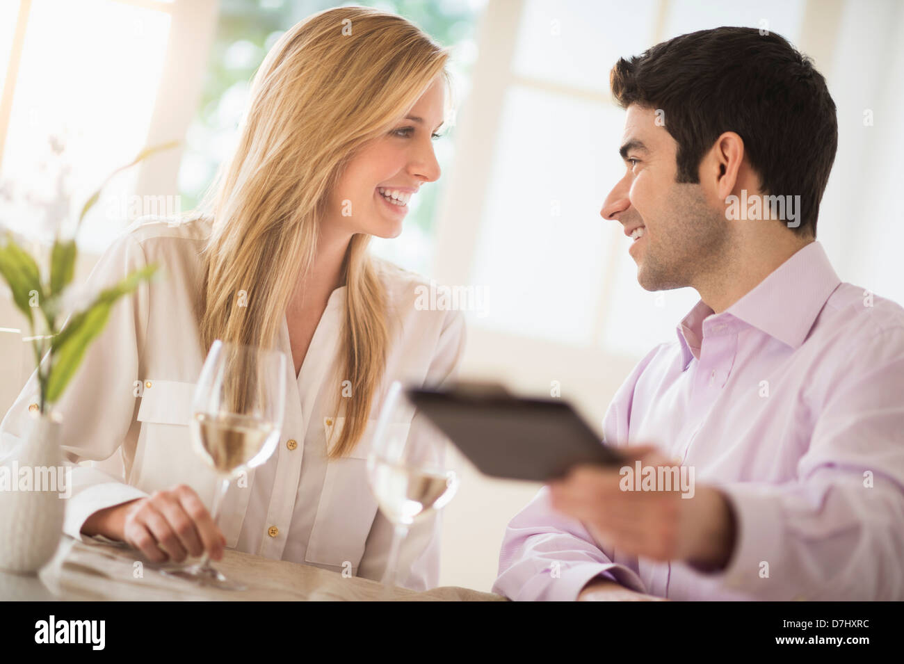 Couple in restaurant, man paying Stock Photo - Alamy