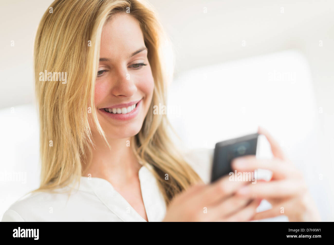 Blond woman texting hi-res stock photography and images - Alamy