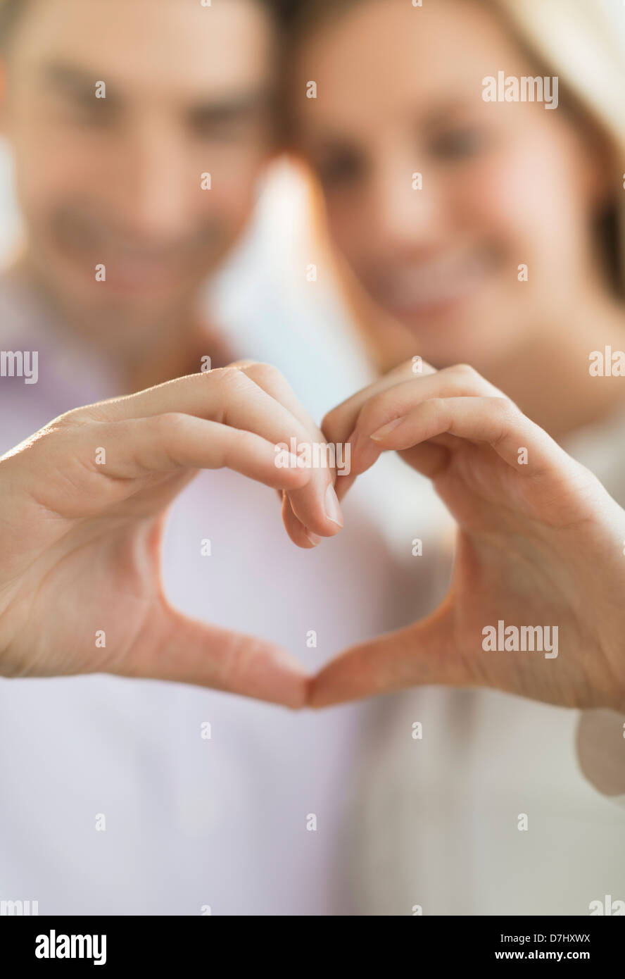 Couple making heart shape with hands Stock Photo - Alamy