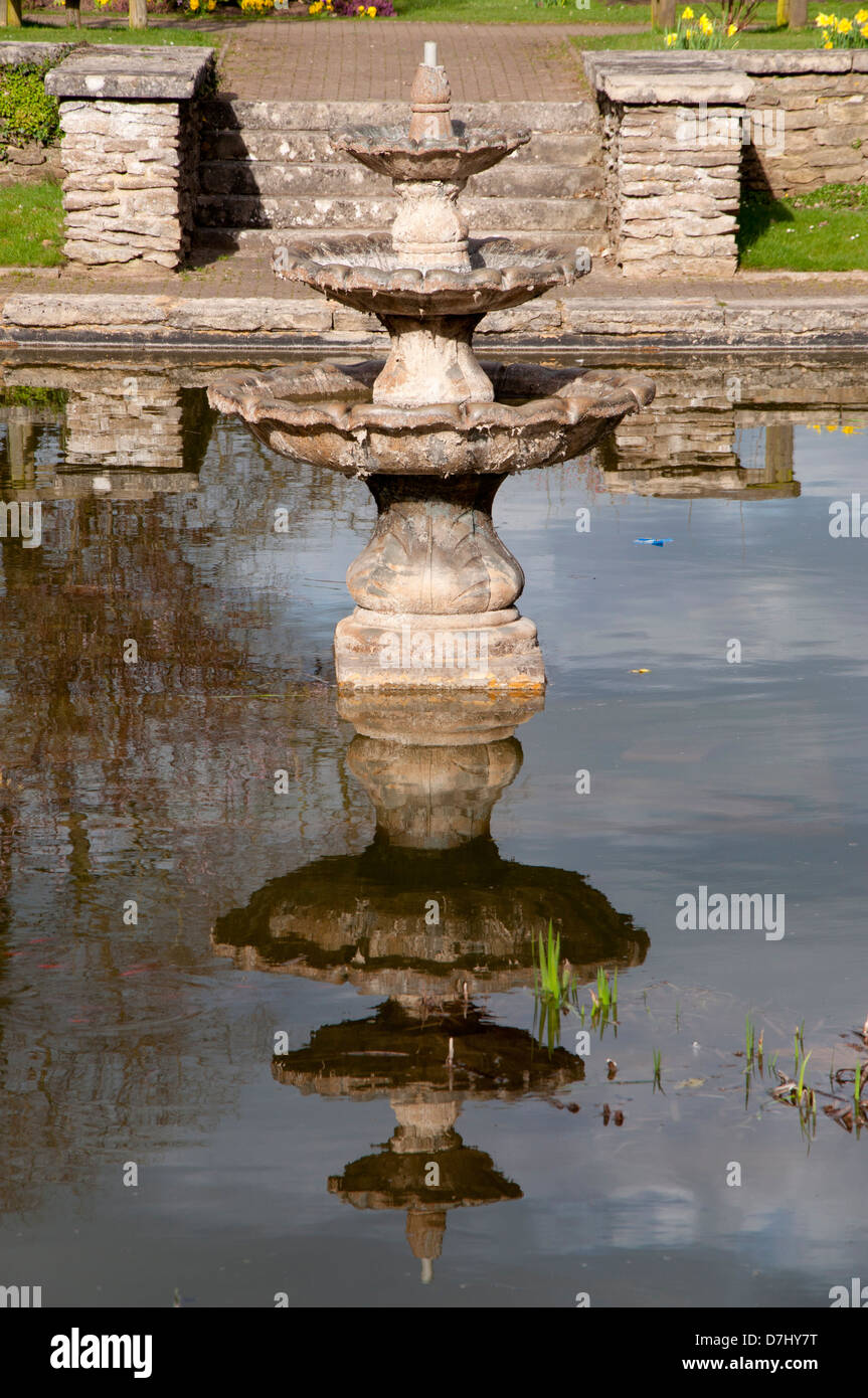 ornate stone fountain, dry, not working, public park, reflection in ...