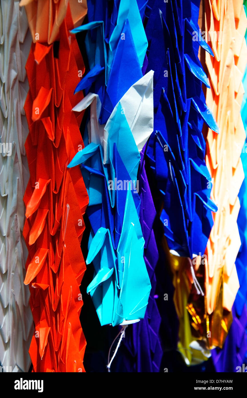 Many Origami Cranes held by strings. In Japan, they are a symbol of ...