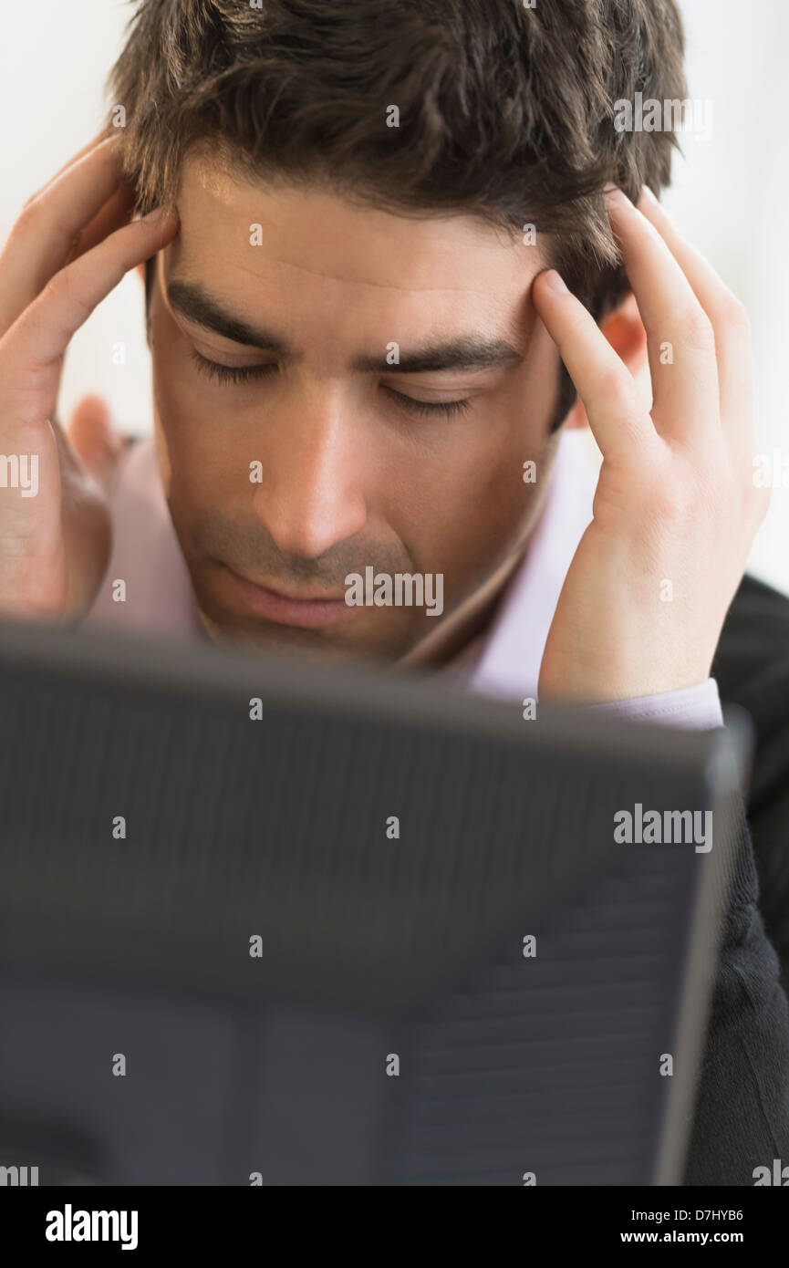 Business man with head in hands Stock Photo - Alamy