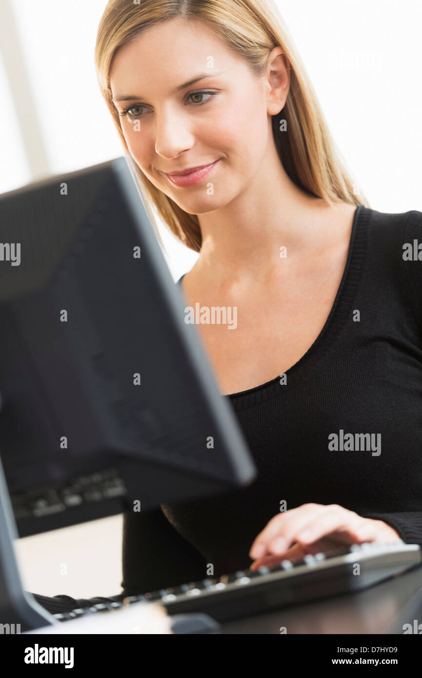 Business woman looking at computer Stock Photo - Alamy