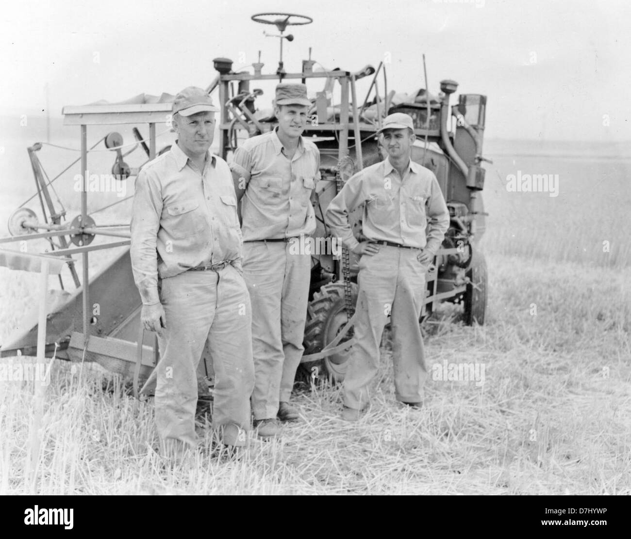 This 1955 photograph shows extension agents working alongside combines ...