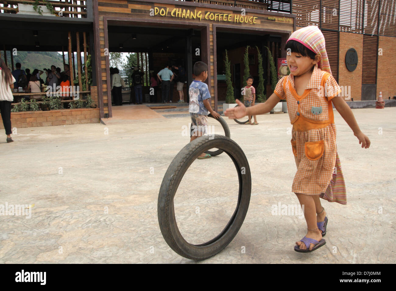Thai hill tribe child playing wheel at Doi Chang , Chiang rai province ...