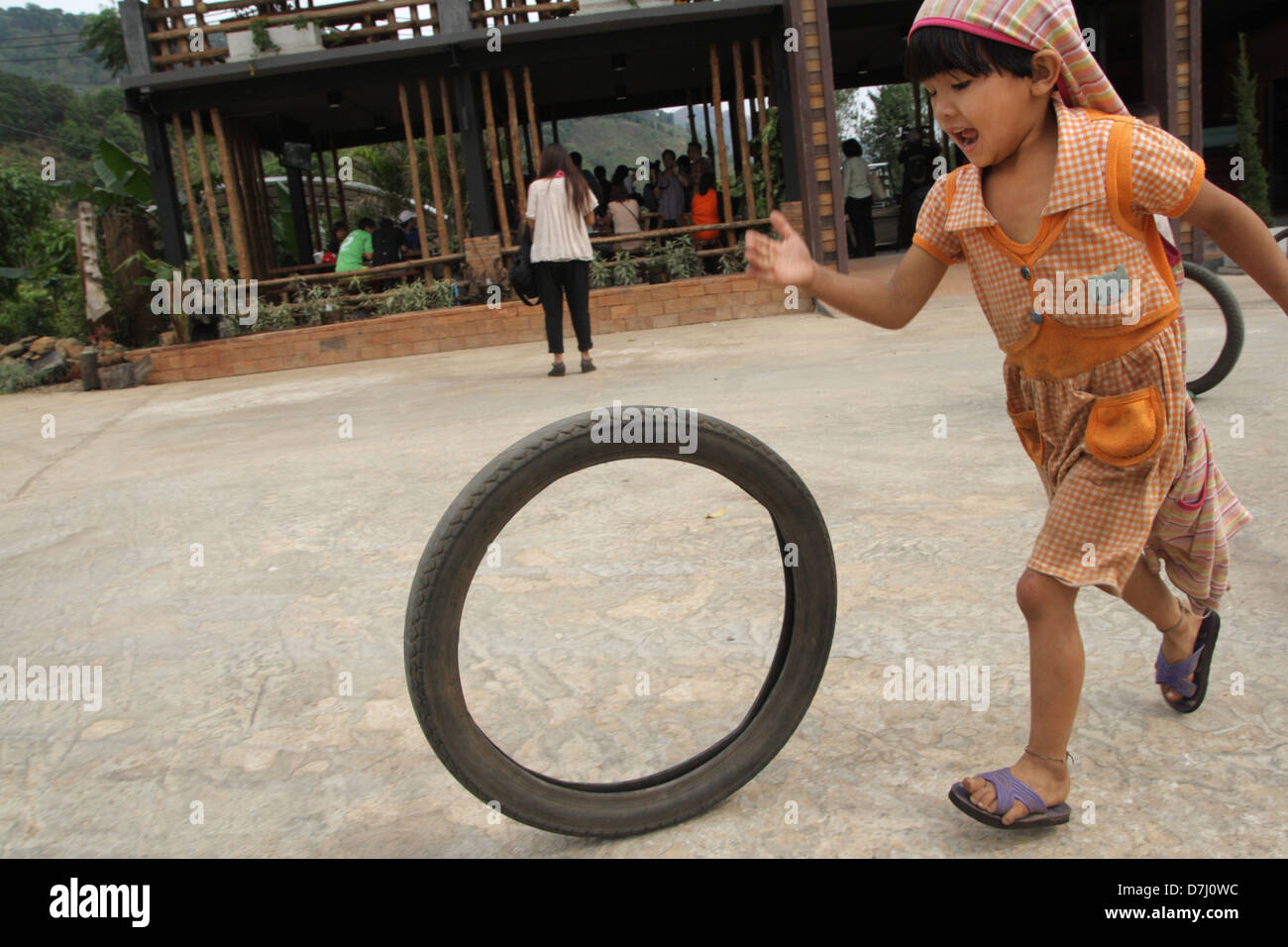 Thai hill tribe child playing wheel at Doi Chang , Chiang rai province ...