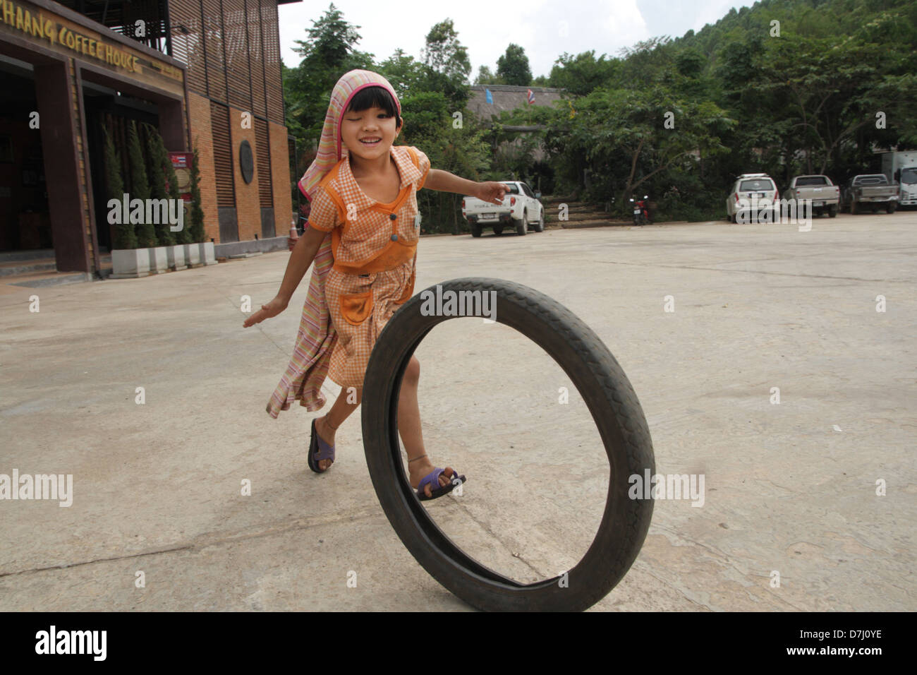 Thai hill tribe child playing wheel at Doi Chang , Chiang rai province ...