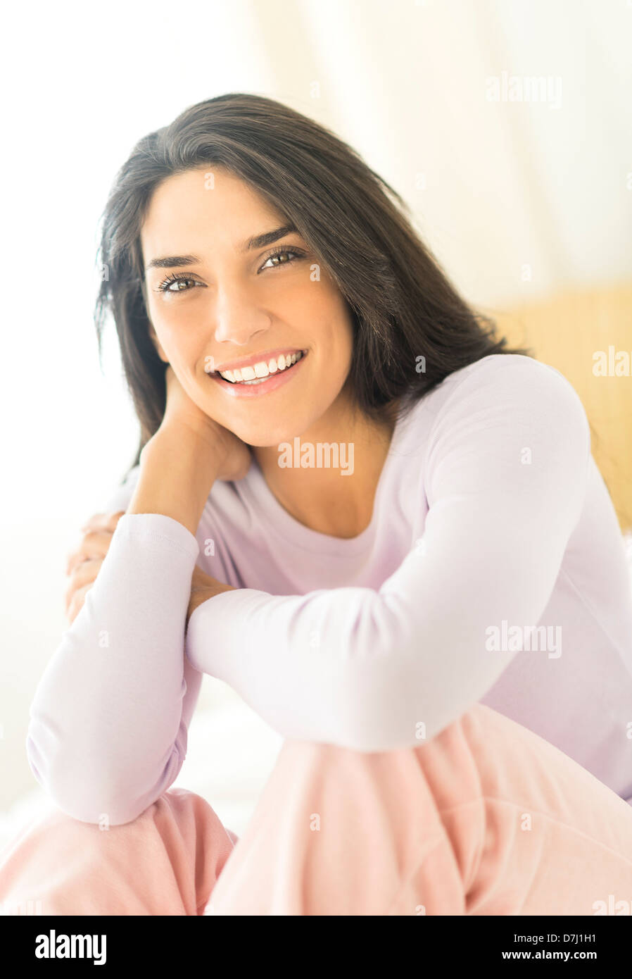 Woman sitting on comfortable bed hi-res stock photography and images - Alamy