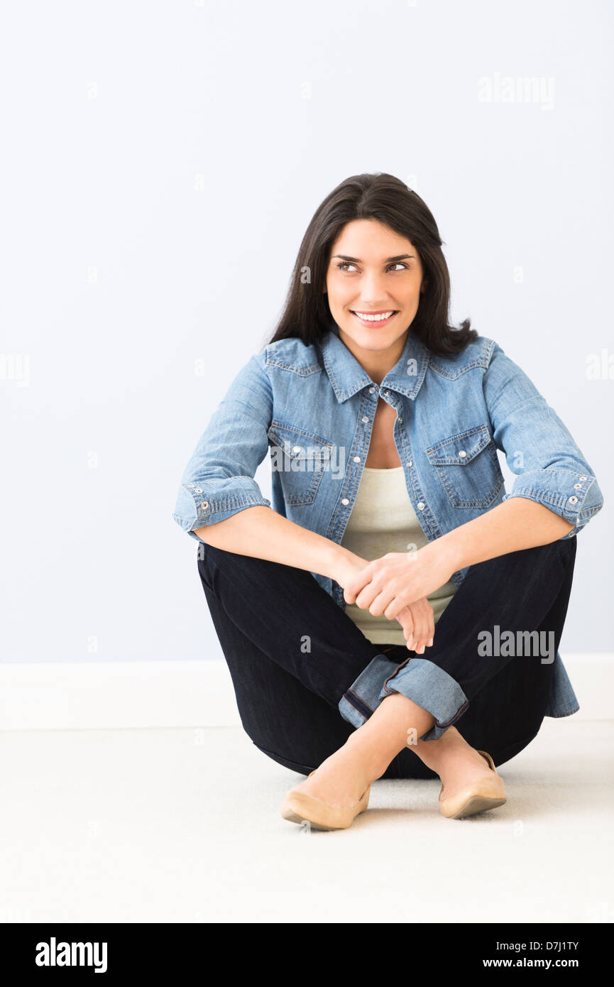 Woman sitting floor studio shot hi-res stock photography and images - Alamy