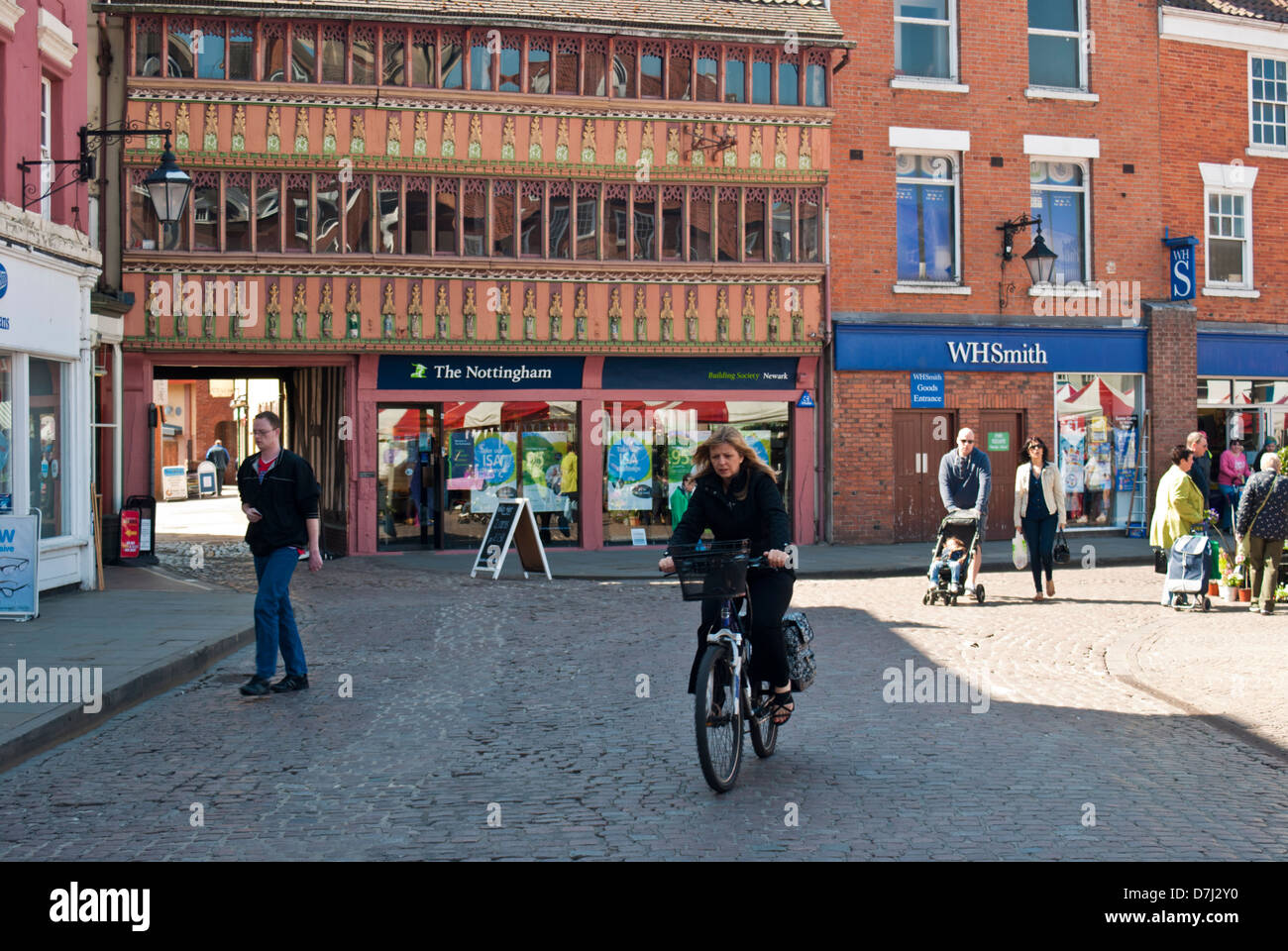 Young woman riding a bicycle in Newark town centre Stock Photo - Alamy