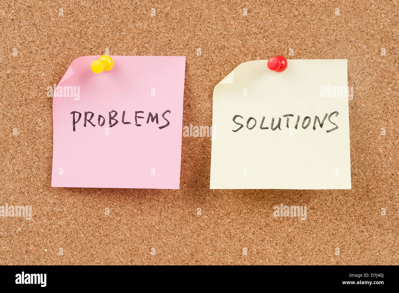 Problems and solutions words written on paper and pinned on corkboard ...