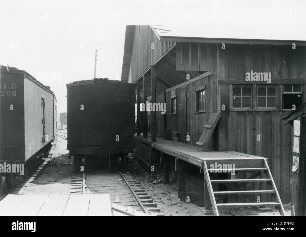 This historic image depicts a refrigerator railroad car at a packing ...