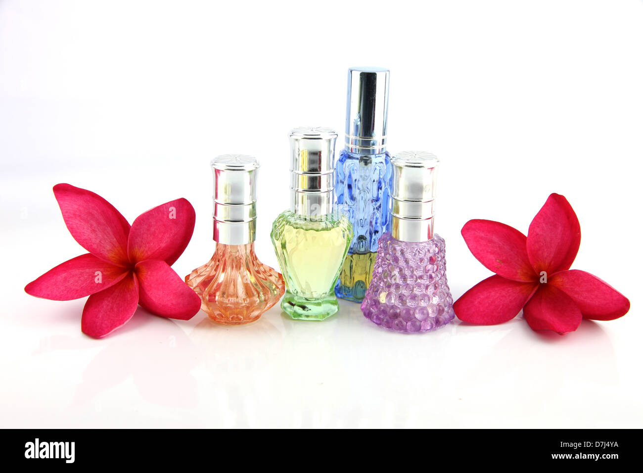The Red flowers and Orange,Blue,Green,Violet Perfume bottles on the ...