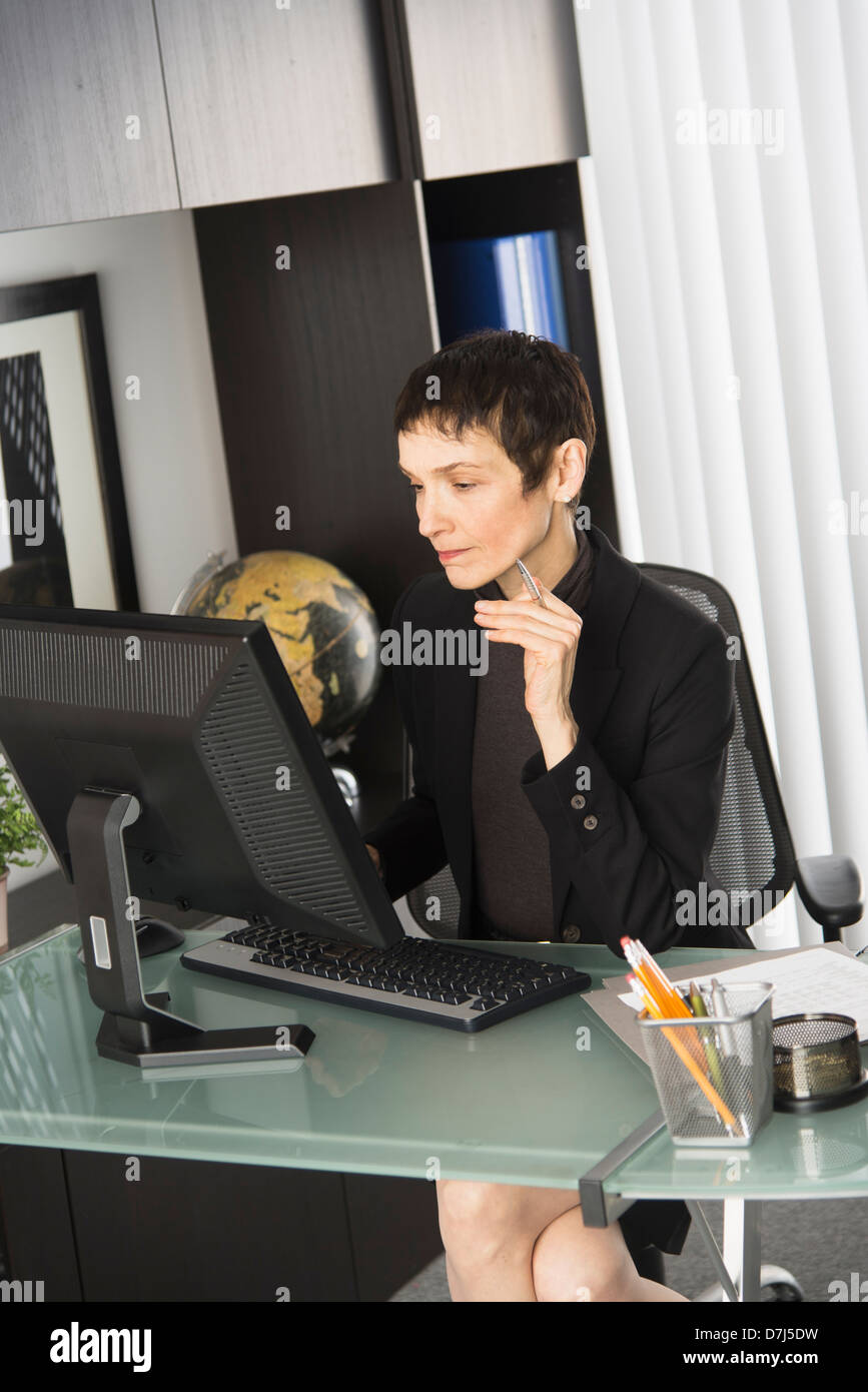 Professional businesswoman working desk hi-res stock photography and ...