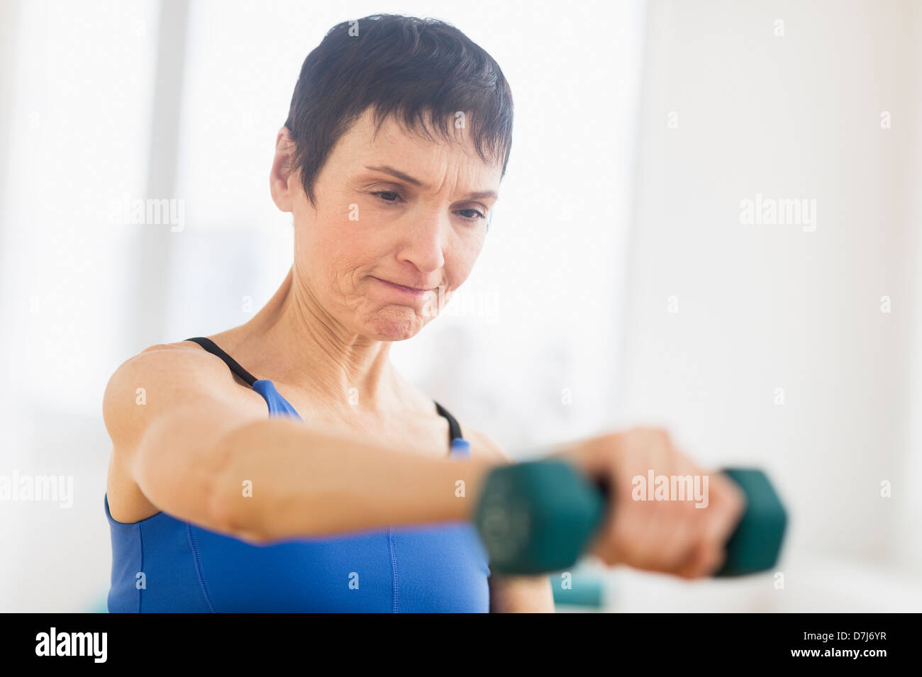 Mature woman exercising in gym Stock Photo - Alamy