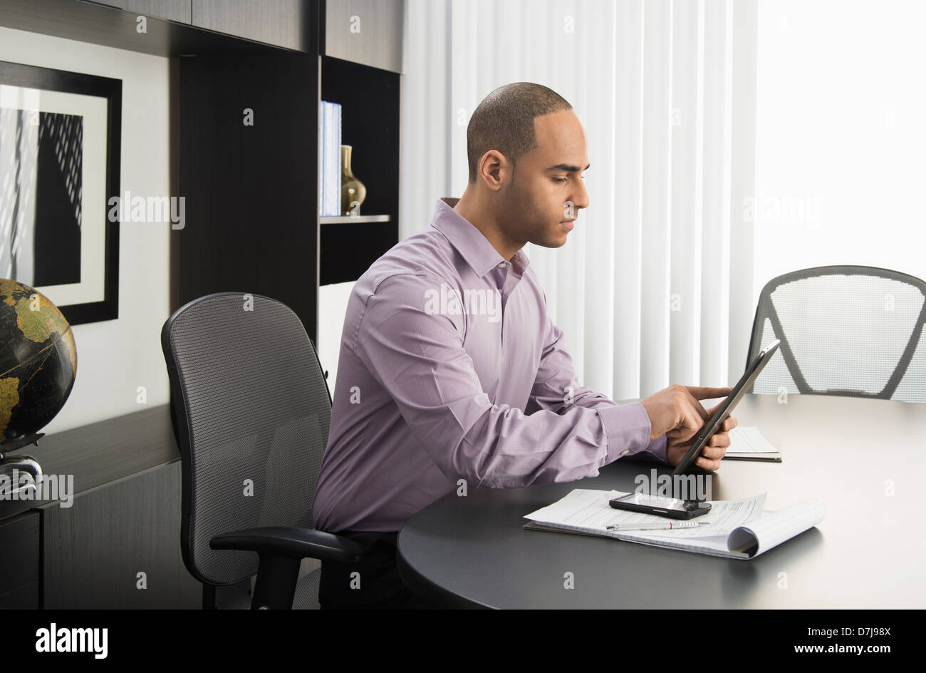 Male executive working at desk in office Stock Photo - Alamy