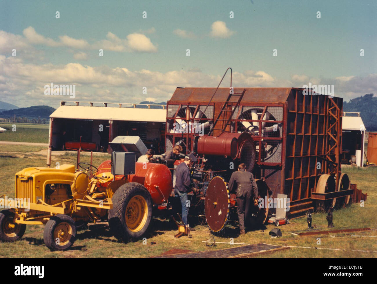 A historical photograph of a field burner and its crew, capturing the ...