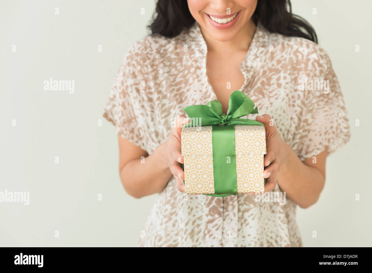Young woman holding present Stock Photo - Alamy