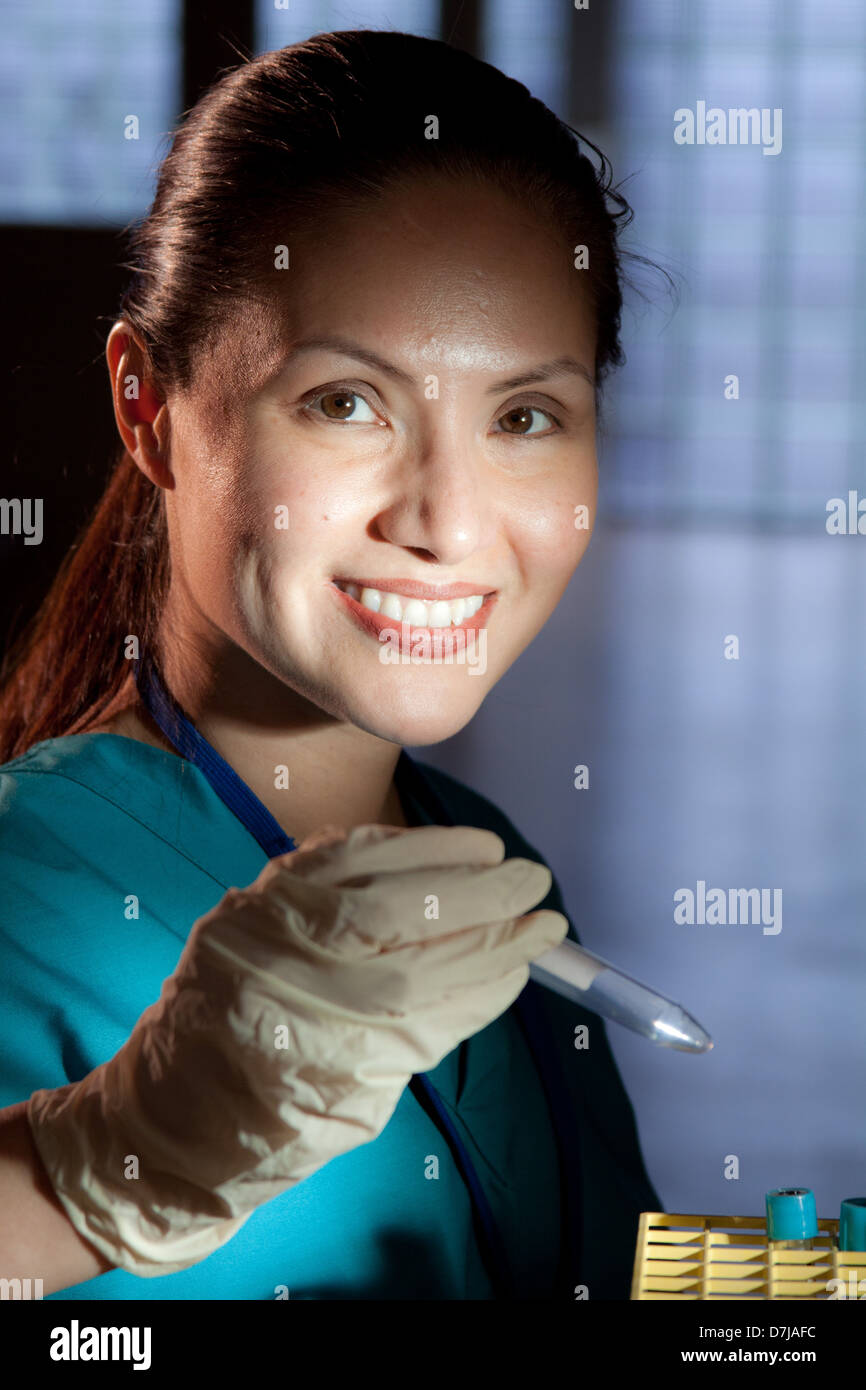 Portrait of Nurse, holding test tube, smiling Stock Photo - Alamy