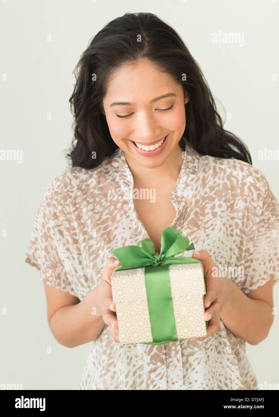 Young woman holding present Stock Photo - Alamy