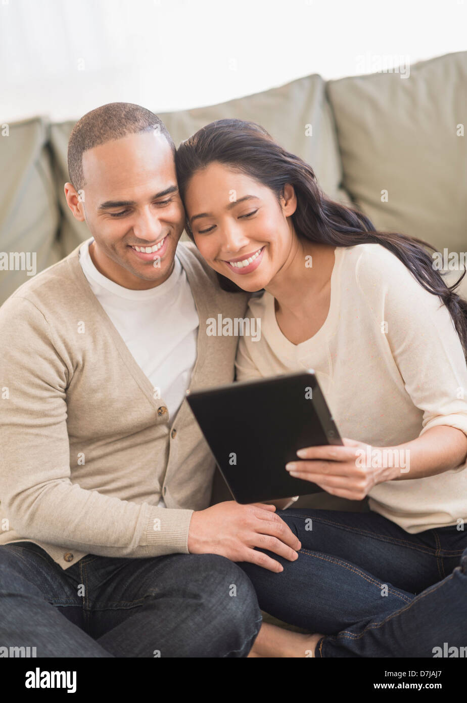 Happy hispanic couple using tablets hi-res stock photography and images - Alamy