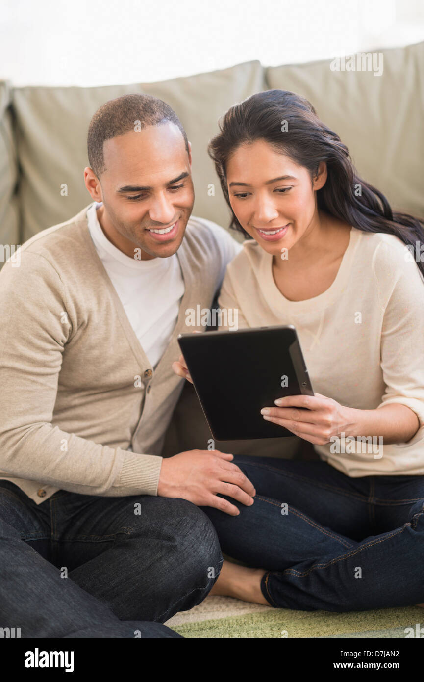 Happy hispanic couple using tablets hi-res stock photography and images - Alamy