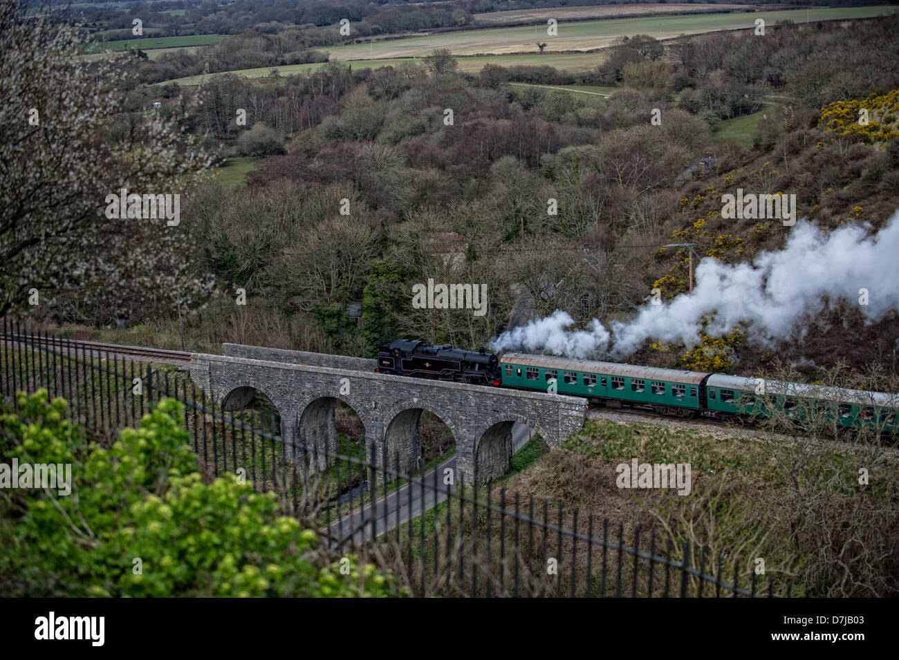 Swanage steam railway train leaving Corfe Castle railway station viewed ...