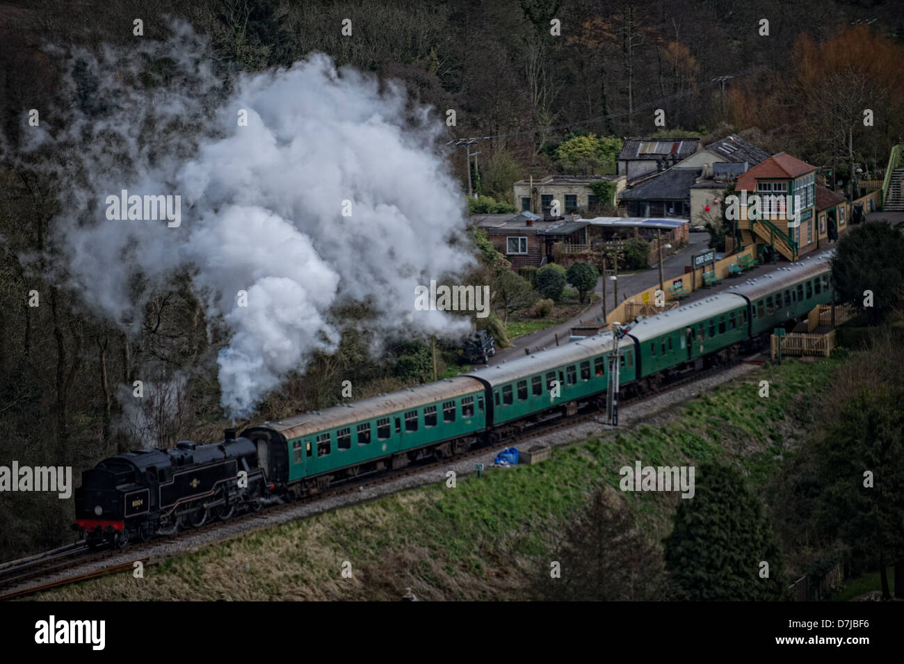 Swanage steam railway train leaving Corfe Castle railway station viewed ...
