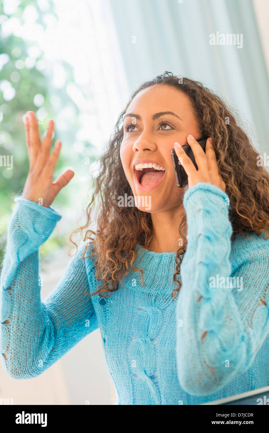 Cheerful young hispanic woman talking hi-res stock photography and ...