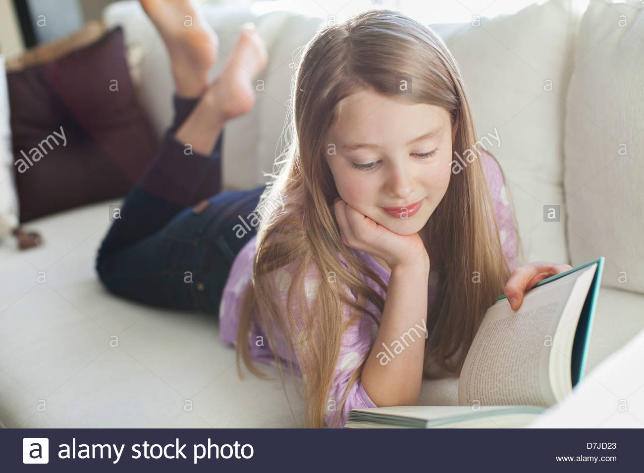 Girl book sofa hi-res stock photography and images - Alamy