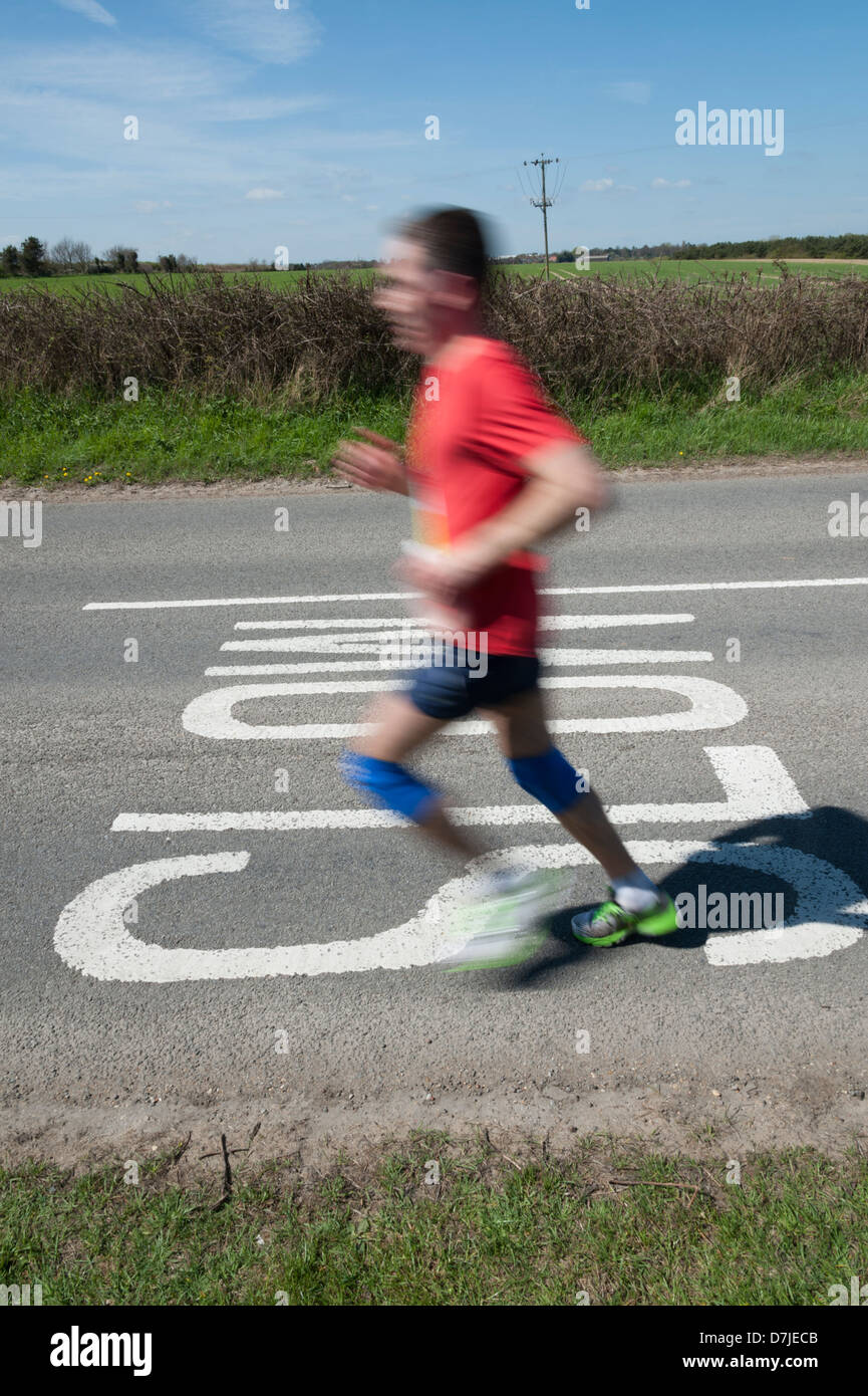 A man running past a slow sign with motion blur Stock Photo - Alamy
