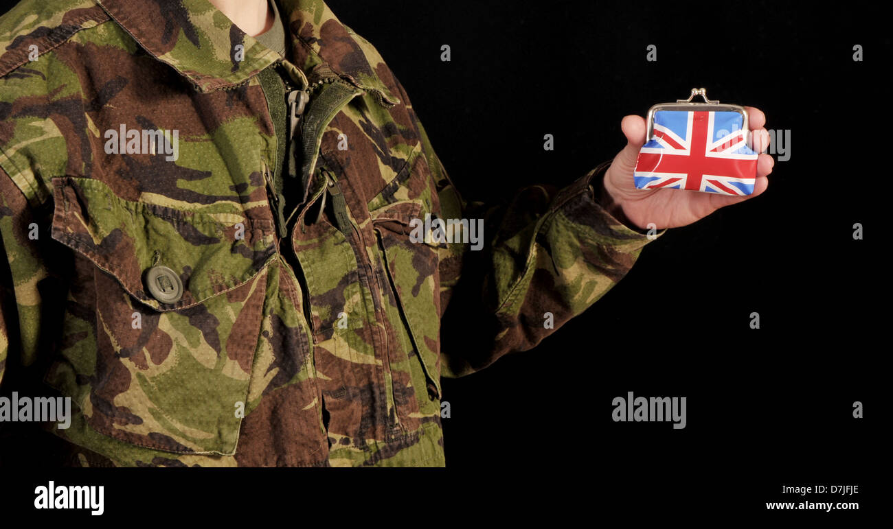 Soldier holding a Union Jack money purse. Soldier is wearing British ...