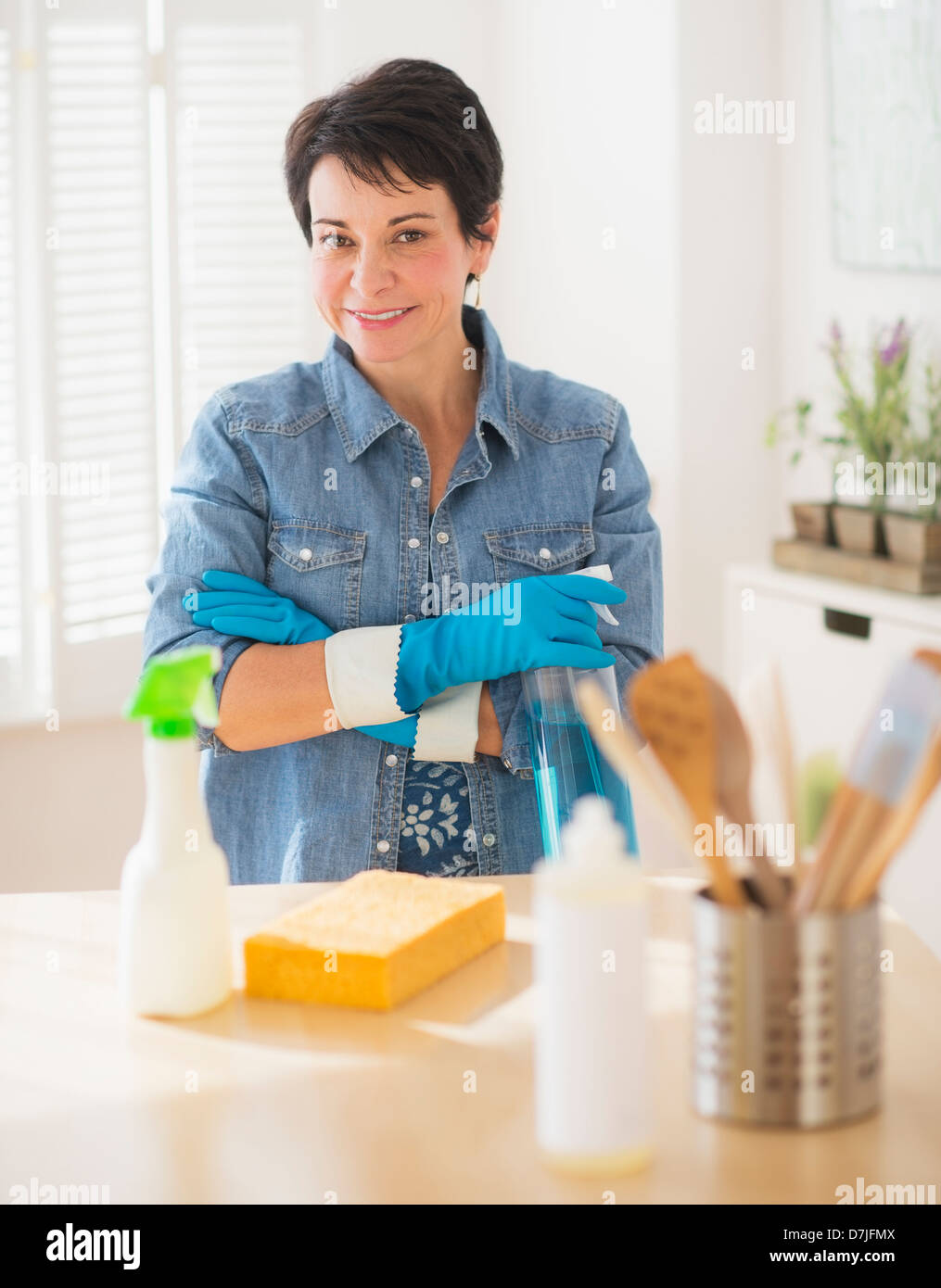 Portrait of mature woman cleaning kitchen Stock Photo - Alamy