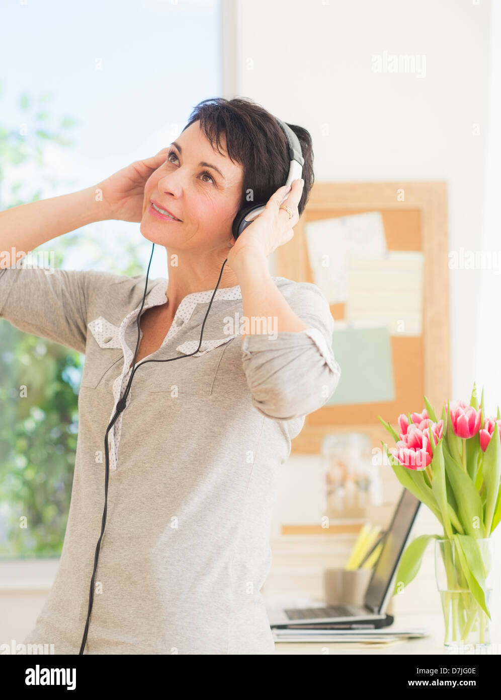 Woman using headphones hi-res stock photography and images - Alamy