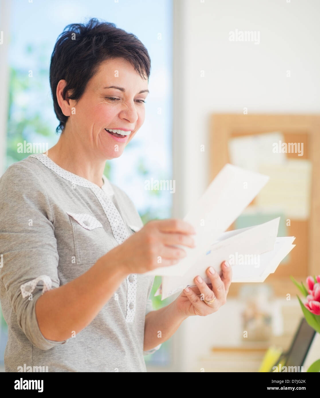 Mature woman reading letters Stock Photo - Alamy