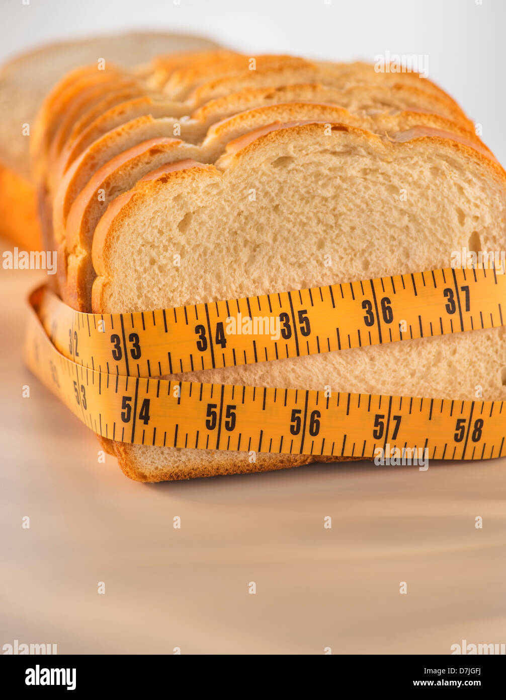 Studio Shot of measuring tape wrapped around slices of bread Stock ...