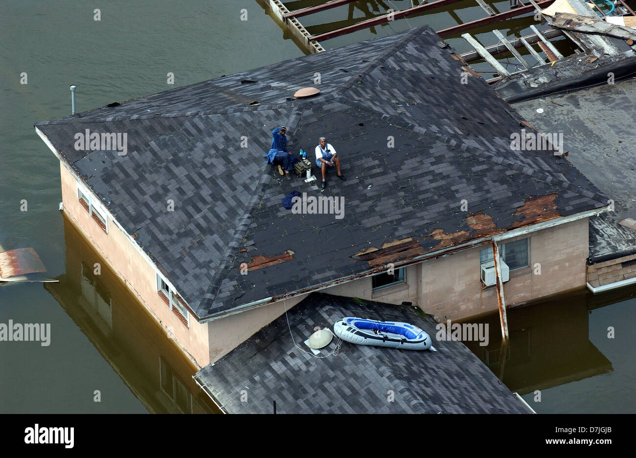 Aerial view showing two residents stranded on their rooftop by massive ...