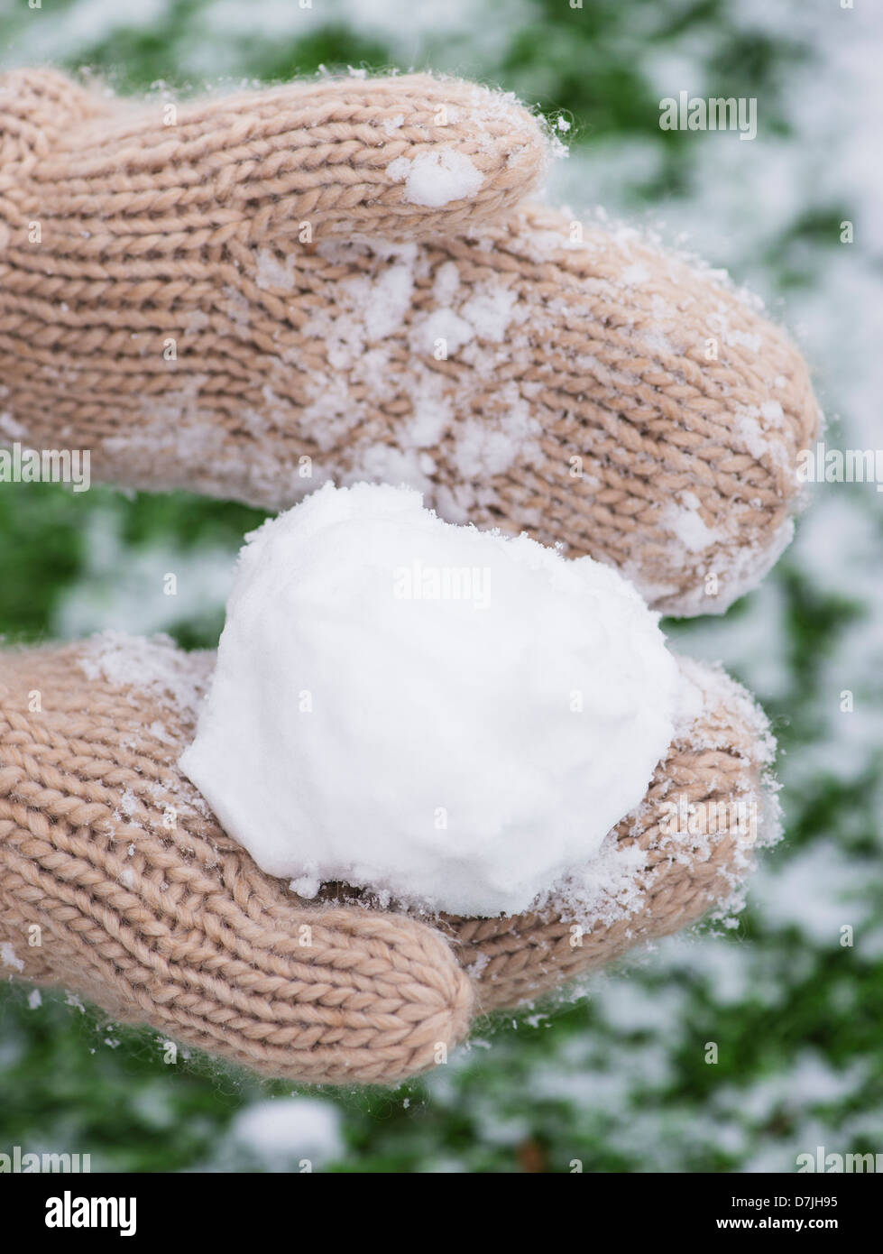 Close-up of snowball and knitted glove Stock Photo - Alamy